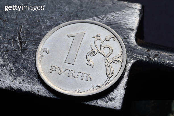 Russian coin denominated 1 ruble. shines on a scratched metal surface ...