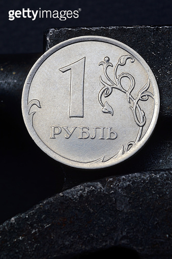 Russian coin denominated 1 ruble. shines on a scratched metal surface ...