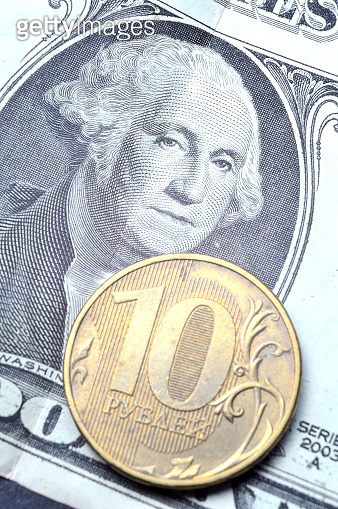 The American dollar on top of which lie Russian coins with a face value ...