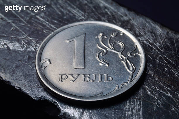 Russian coin denominated 1 ruble. shines on a scratched metal surface ...