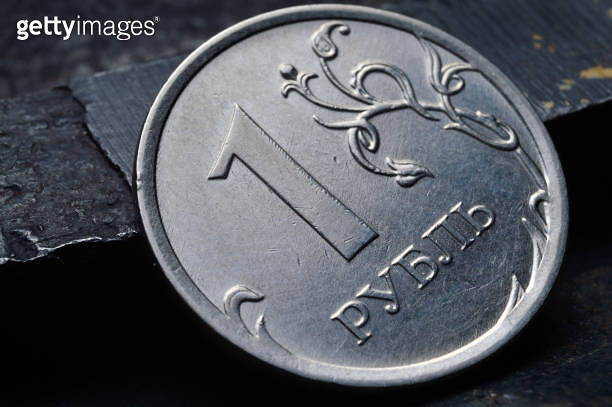 Russian coin denominated 1 ruble. shines on a scratched metal surface ...