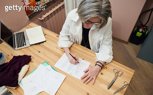 Top view of an inspired mature Caucasian female fashion designer ...