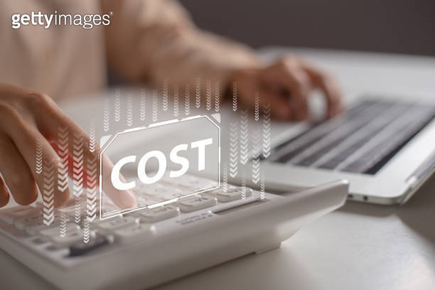 Accountants using calculator to calculate corporate cost reduction ...