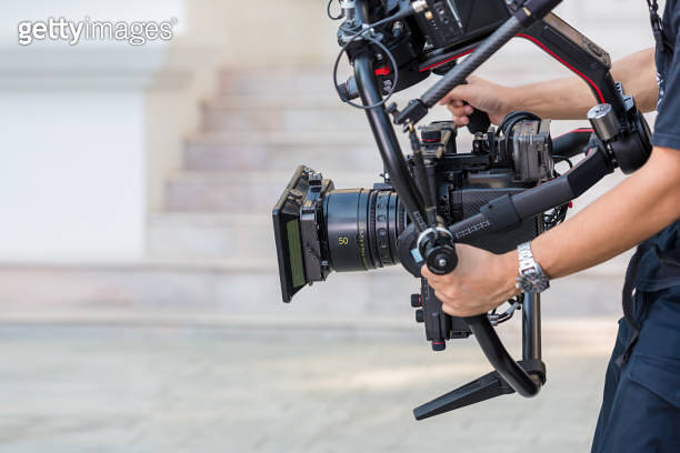 Movie shooting or video production and film crew team with camera ...