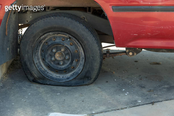 Destroyed blown out tire with exploded, shredded and damaged tire on a ...