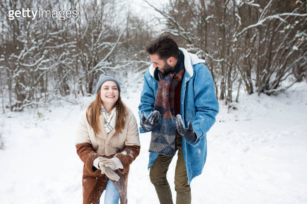 Romantic winter scene, happy young couple having fun on fresh show on ...