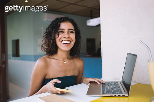 Cheerful Middle Eastern female blogger with modern smartphone and ...