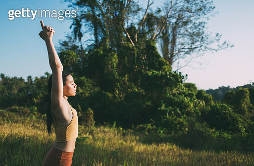 Young caucasian woman with closed eyes standing on meadow feeling ...