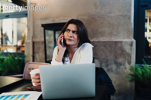 Puzzled female freelancer confused on received news during coffee break ...