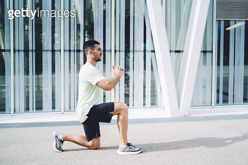 Side view of athletic male in sportswear keeping healthy lifestyle ...