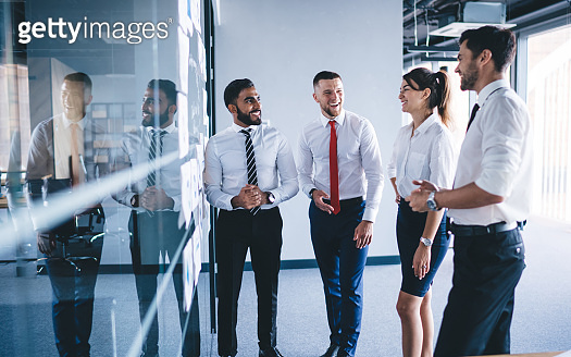 Happy diverse executive managers in formal clothing discussing ...