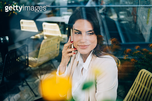 Beautiful caucasian woman making mobile phone call satisfied with ...