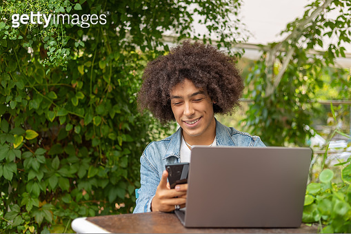 Smiling young ethnic Afro-Italian man 20 years old, dressed in casual ...