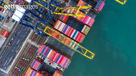 Container Cargo freight ship with working crane loading bridge ...