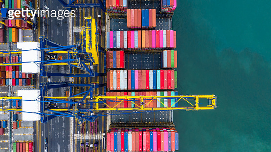 Container Cargo freight ship with working crane loading bridge ...