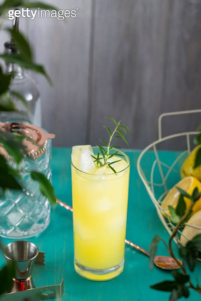 Pear Colins Cocktail. Highball glass filled with pear puree cocktail or ...