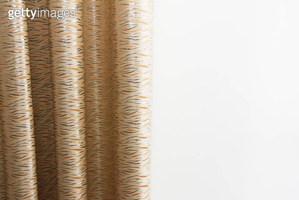 the texture of beige curtain fabric with a shiny pattern with ...