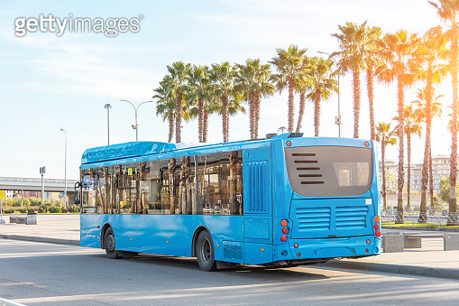 Blue city bus at a final stop of the route stop waiting for passengers ...