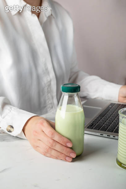 business woman using computer and having a healthy alternative milk ...