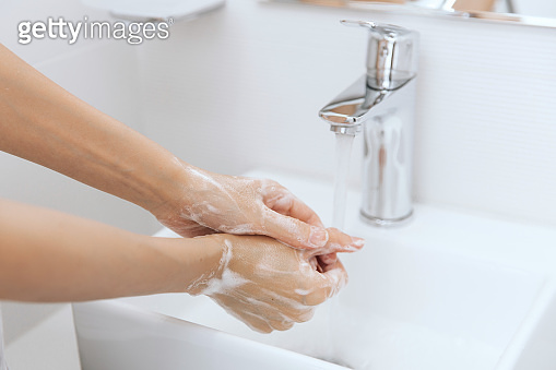 Washing hands under the flowing water tap. Hygiene concept hand detail ...
