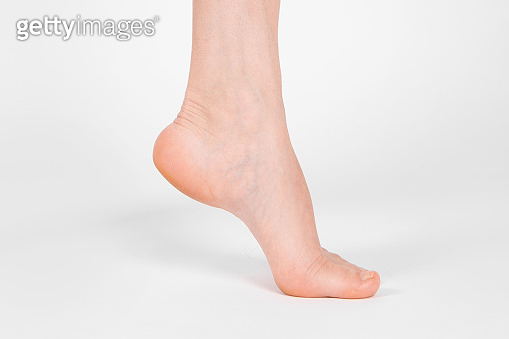 Barefoot and legs isolated on white background. Closeup shot of healthy ...