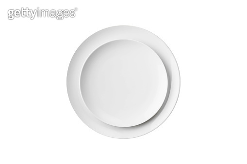 Two white plates of different sizes isolated on white background. Top ...