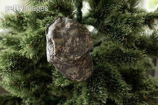 Christmas in the army. ball and gift box, military uniform, closeup ...