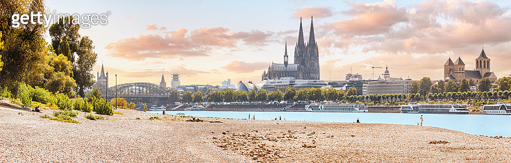 Panoramic view of the Rhine River beach and the Cologne skyline with ...