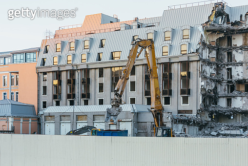 Cleaning of construction debris with a bucket of an excavator, the ...
