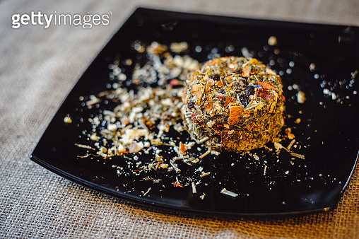 The round head of the French spicy cheese Boulette d'Avesnes sprinkled ...