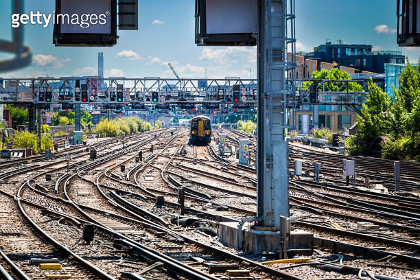 Railroad tracks in a row at major railroad station with passenger train ...