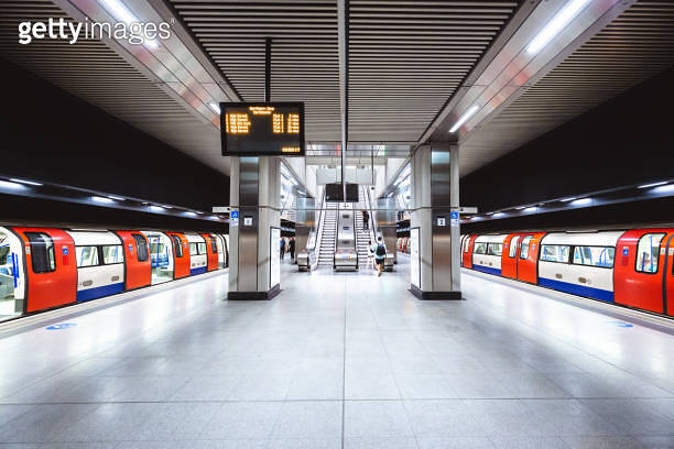 Tube trains waiting at modern architecture of new underground station ...