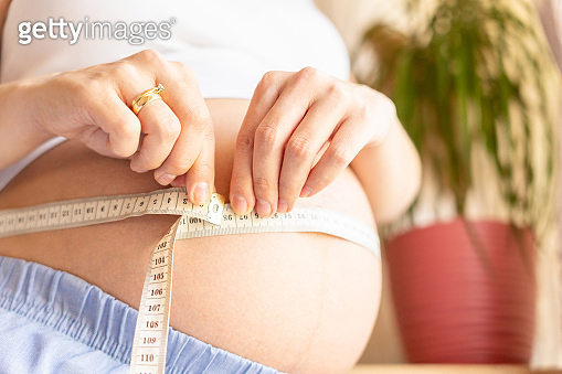 Measure body pregnancy woman. Happy beautiful pregnant woman with tape ...