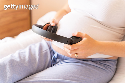 Pregnant music woman listen. Mother belly listen headphones sound ...