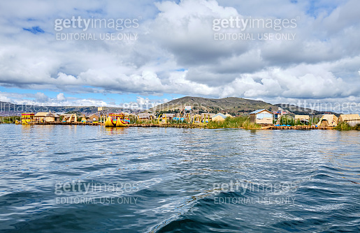 Floating islands with indigenous peoples houses made of reeds on ...