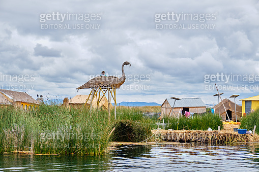 Floating islands with indigenous peoples houses made of reeds on ...