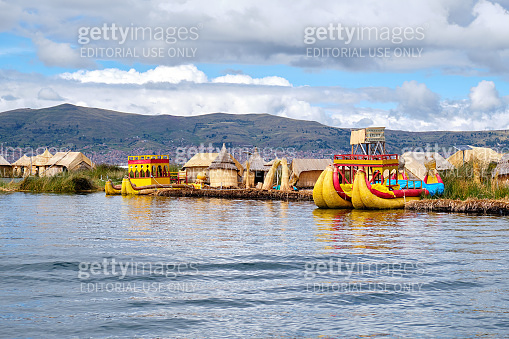 Floating islands with indigenous peoples houses made of reeds on ...
