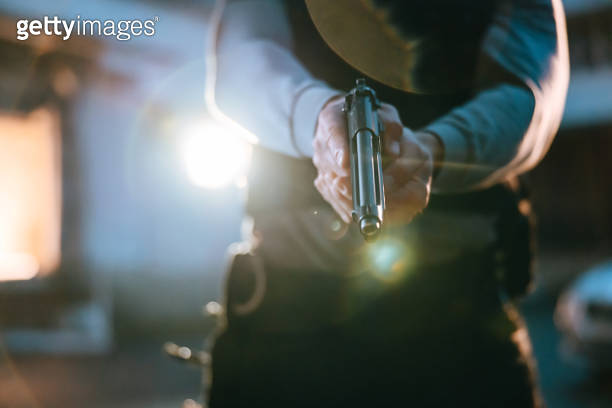 Task force officer holding a handgun in the middle of the crime scene ...