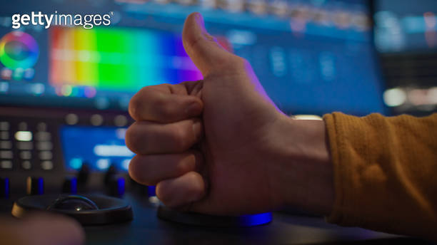 Male editor hand giving thumbs up sign beside computer at desk 이미지 ...