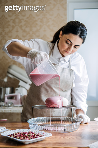 Central Asian Arabic woman pastry chef making Mirror Glaze Mousse cake ...
