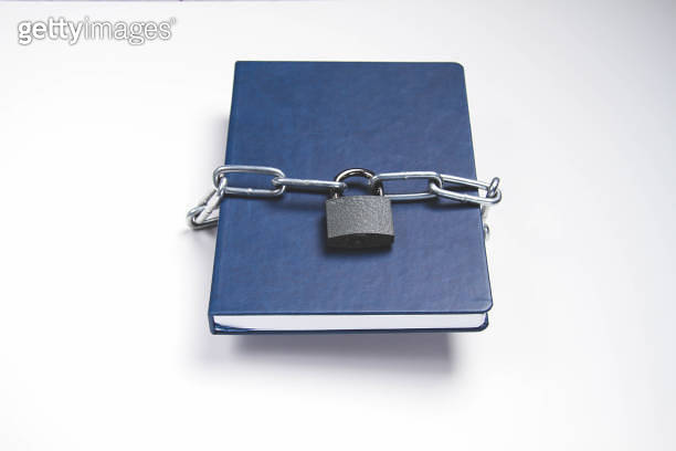 The book is locked under lock and key on a white background. Secret ...
