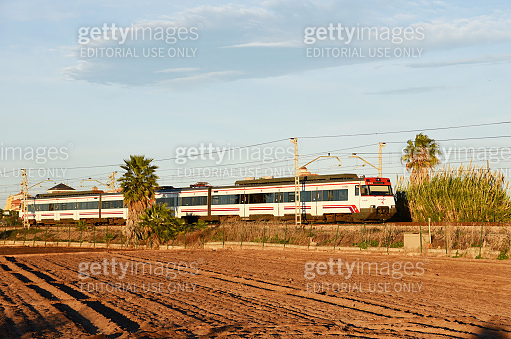RENFE 447 120Rcommuter train in motion on railway. RENFE SNCF - Spanish ...