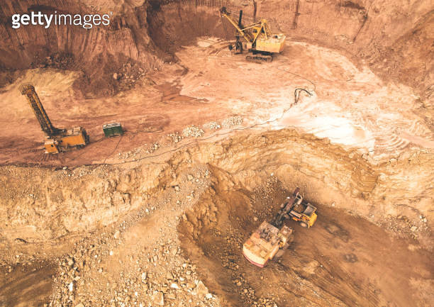 Excavator in open pit on dolomite development. Mining clay in quarry ...