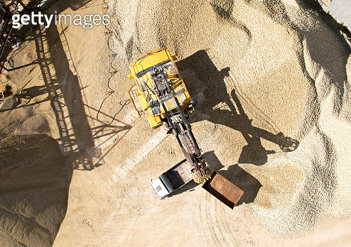 Mining excavator with electric shovel loading sand into haul truck in ...