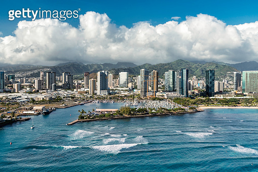 Aerial view of city tall buildings in Honolulu and boat harbor by the ...
