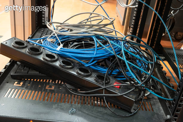 Messy cable bunch. Power, extension cord, Ethernet cables all tangled ...