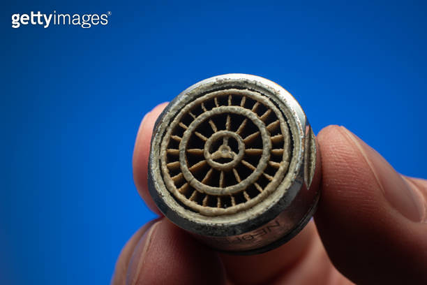 Old dirty limescale covered clogged up tap water faucet strainer or ...