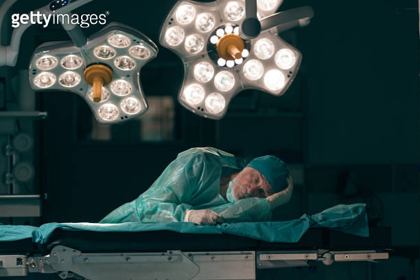 Senior surgeon is feeling sad and tired after unsuccessful surgery ...