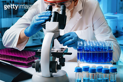 Microbiologist working with biological samples in microscope of the ...