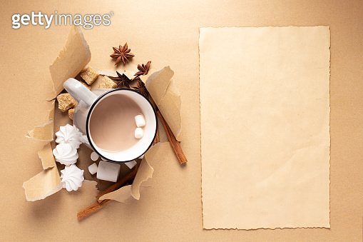 Cup cacao and ingredients in torn paper. Coffee with milk and paper ...